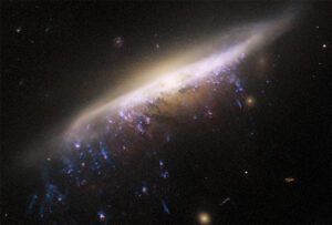 Hubble captures a ‘jellyfish’ swimming through a remote galactic ...